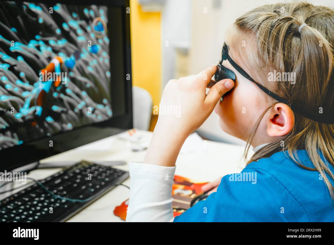 Little girl in medical office undergoing advanced laser vision ...