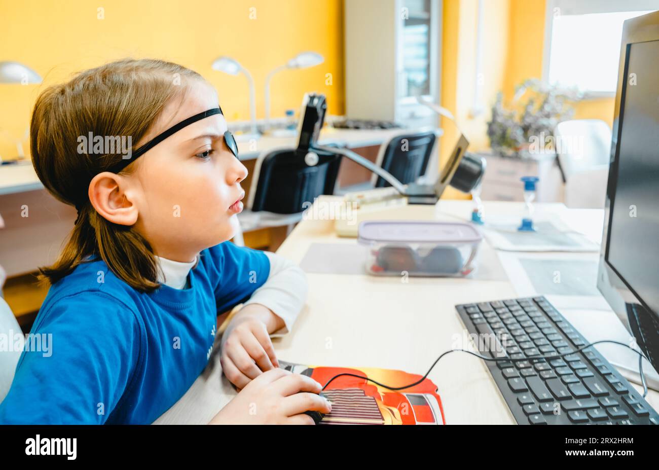 Little girl in medical office undergoing advanced laser vision ...