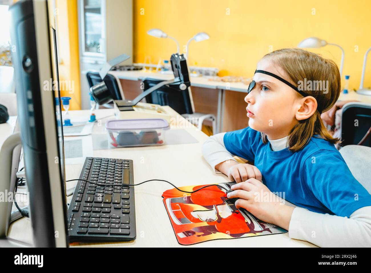 Little girl in medical office undergoing advanced laser vision ...