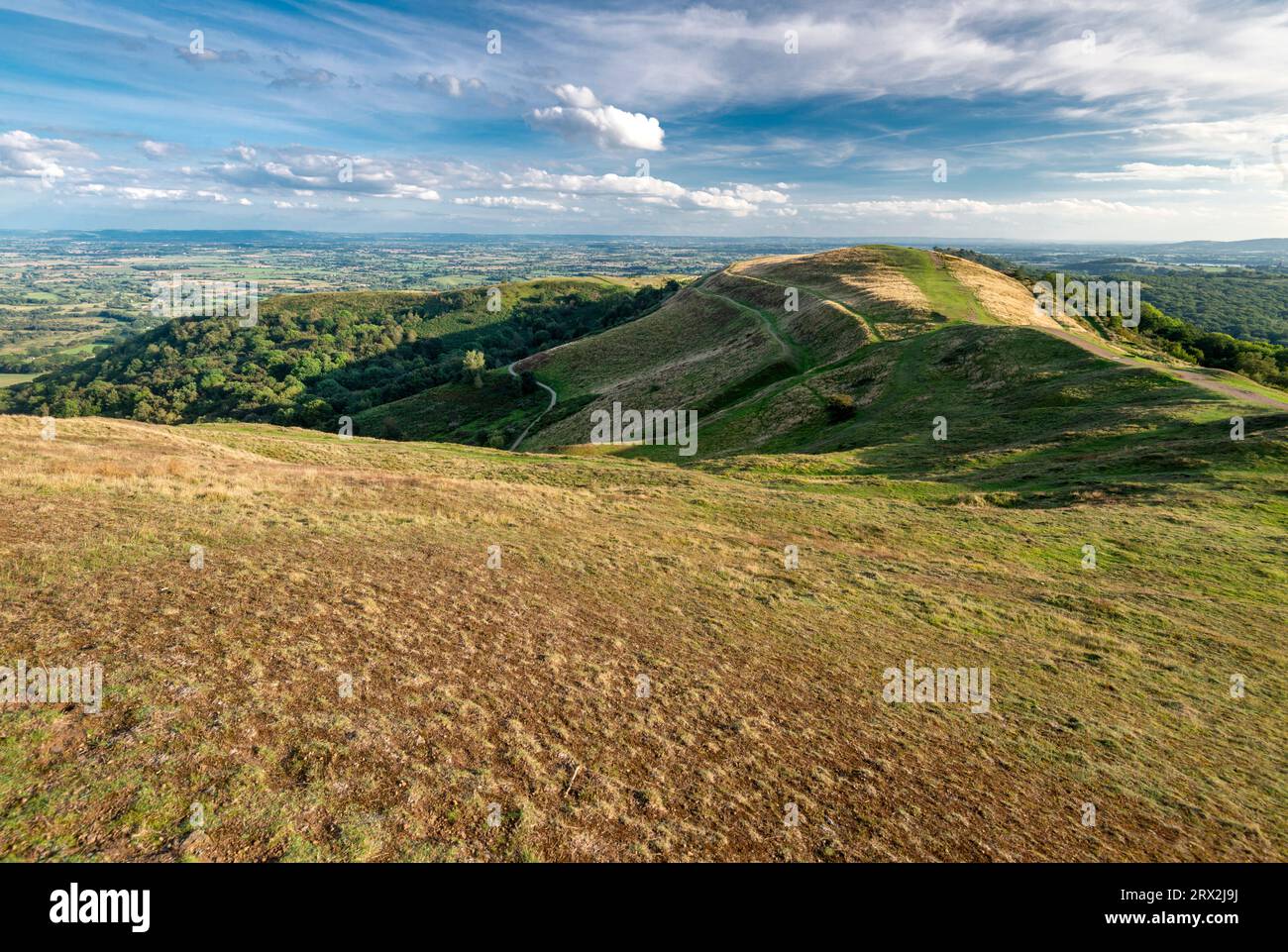 Southern end of Malvern Hills,smooth green hillsides run down from ...