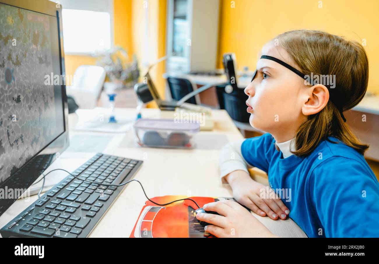 Little girl in medical office undergoing advanced laser vision ...