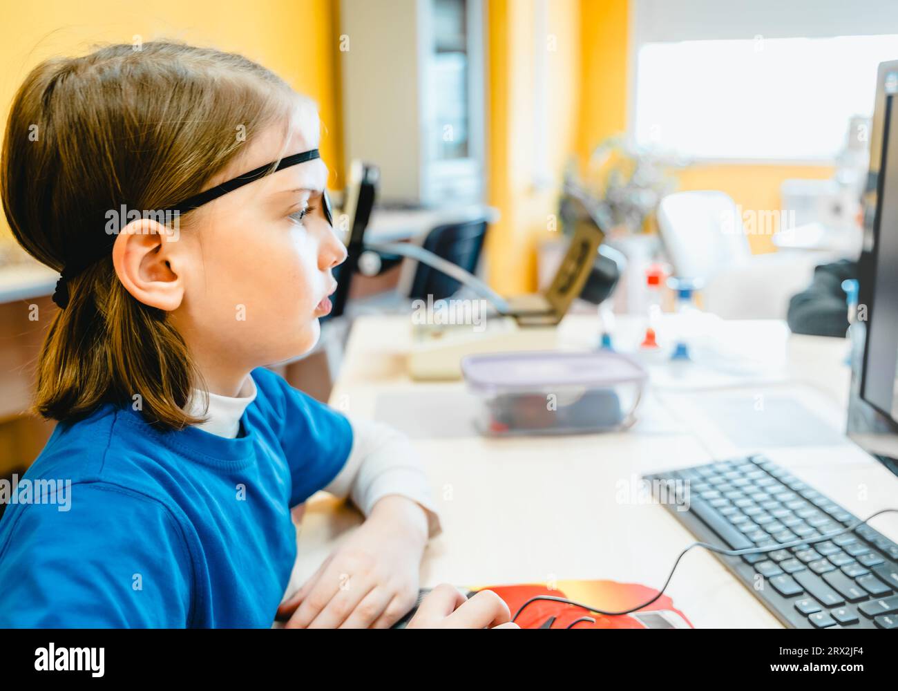Little girl in medical office undergoing advanced laser vision ...