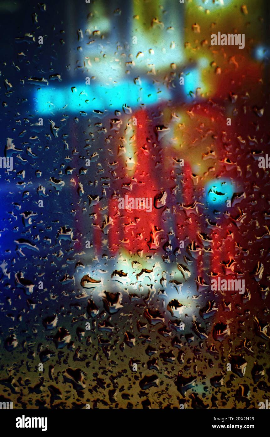 window with drops of rain and blurred night city scene behind it Stock ...
