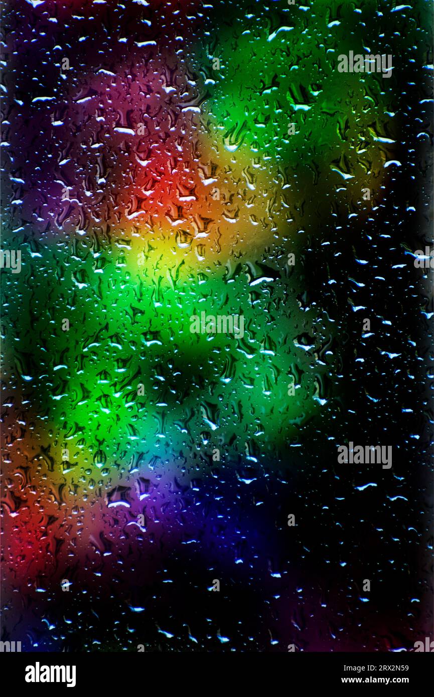 window with drops of rain and blurred night city scene behind it Stock ...