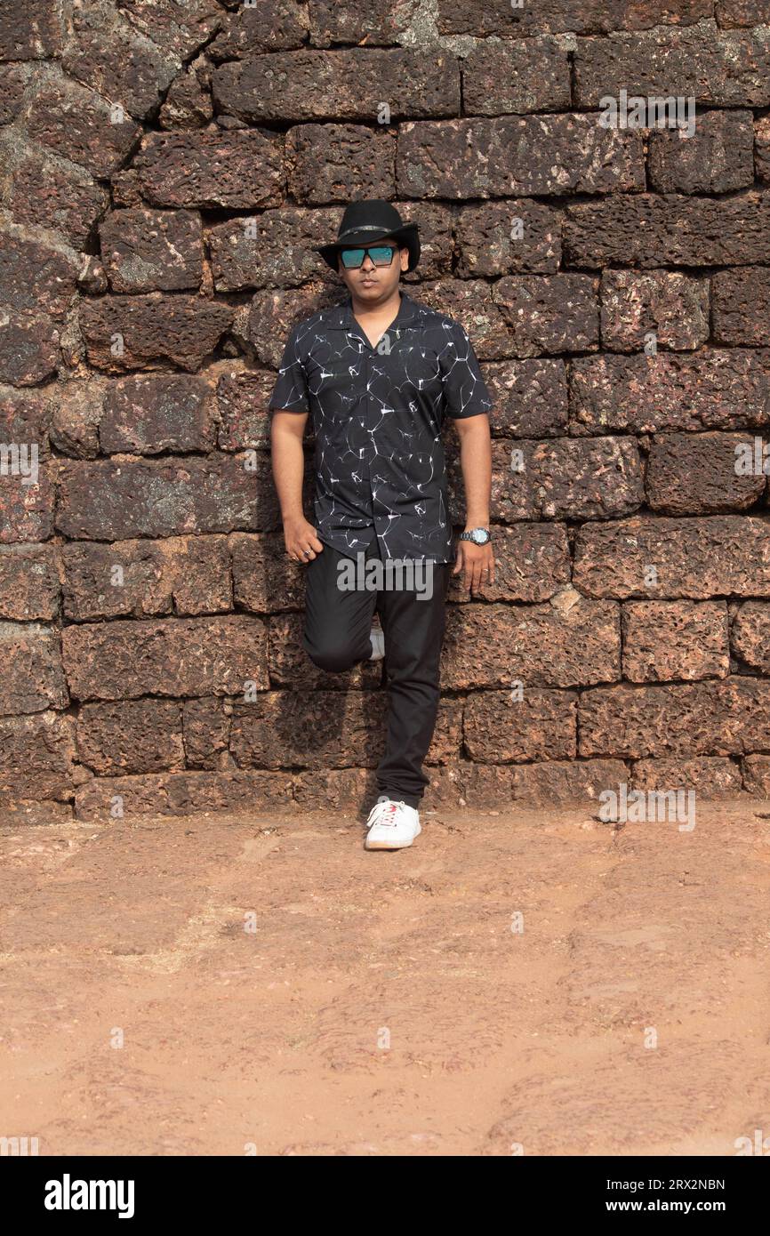 Man Leaning Against Wall Hat