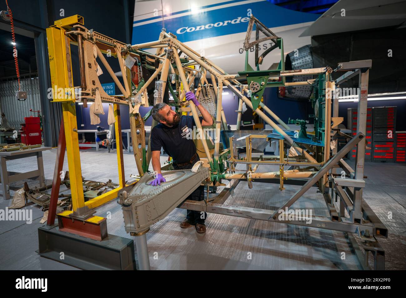 Conservation Engineer Will Gibbs inspects the cockpit airframe while ...