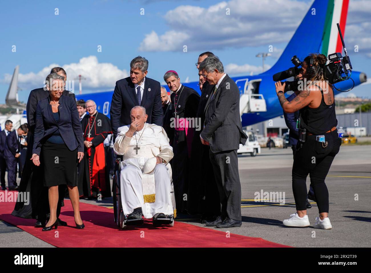 Pope Francis is welcomed by French Prime Minister Elisabeth Borne, left ...