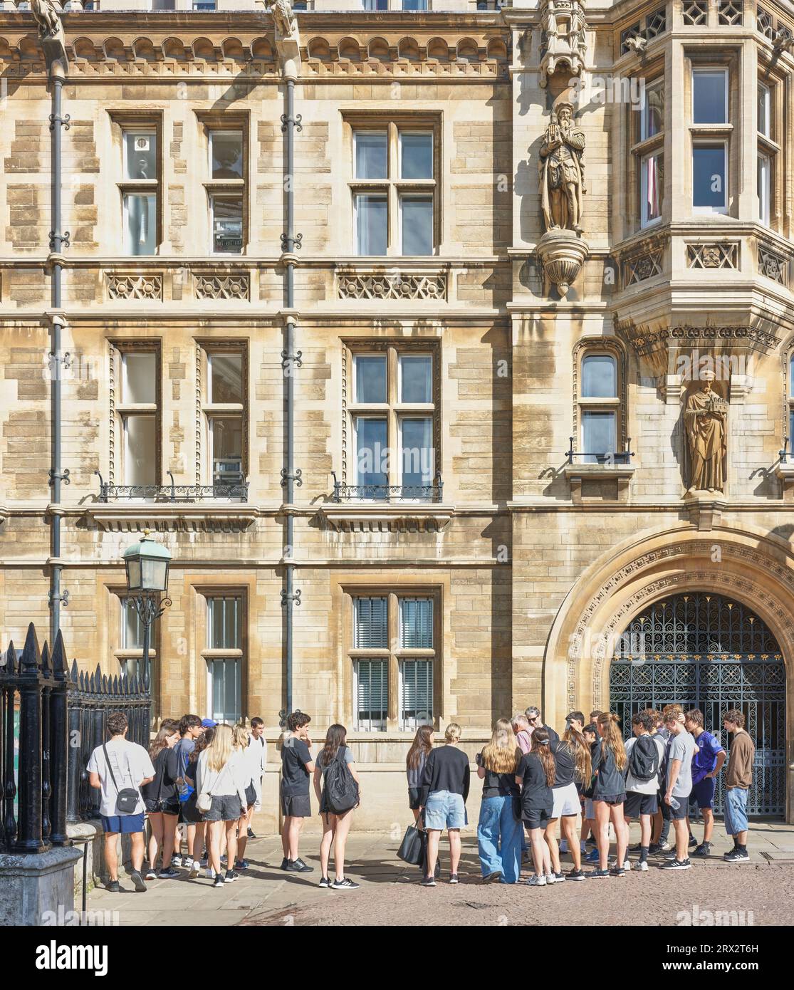 Student tourists outside the prestigious college of Gonville & Caius at the university of ...