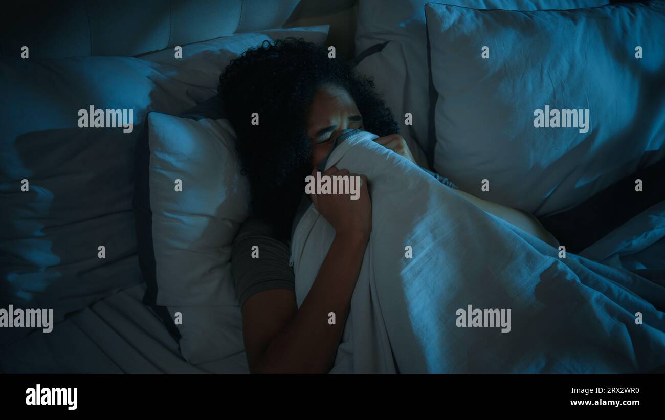 African american woman lying on bed night nightfall dark home bedroom ...