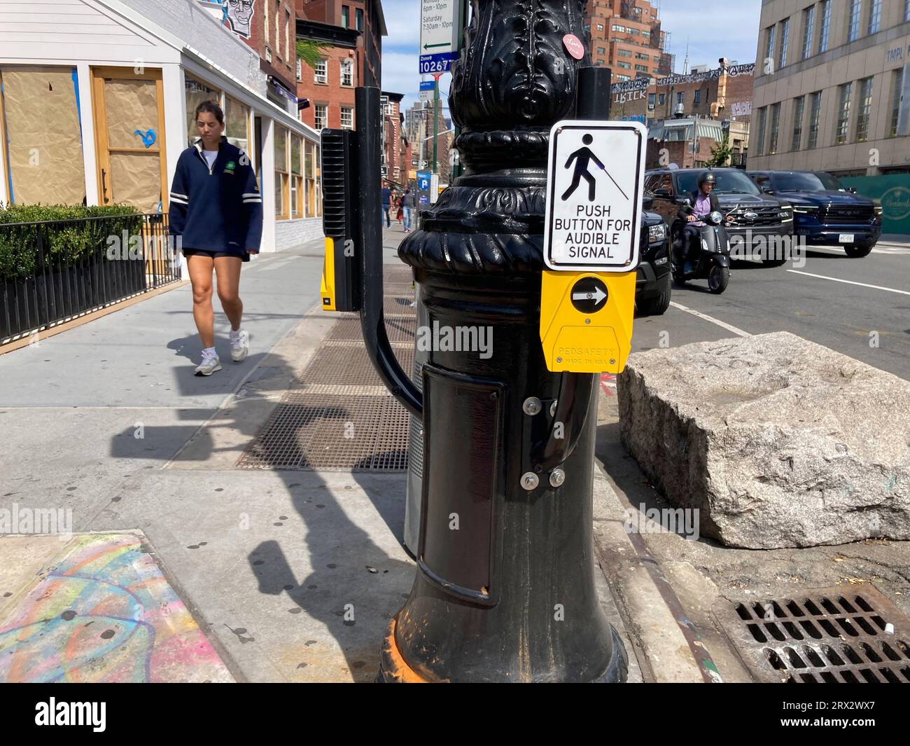 An audible crosswalk signal attached to a light pole is seen in New ...