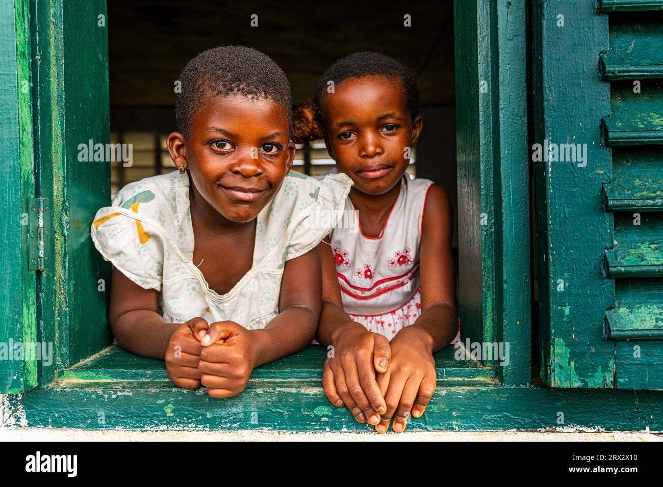 Young school kids looking out from a window, Ciudad de la Paz, Rio Muni ...
