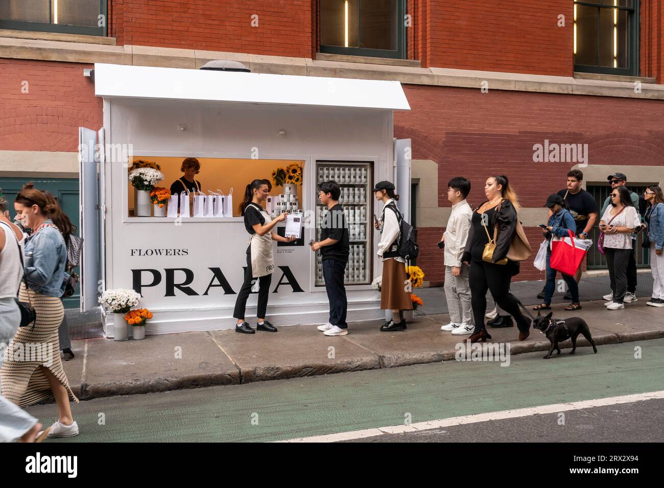 Crowds of shoppers line up for a Prada brand activation in the Soho ...