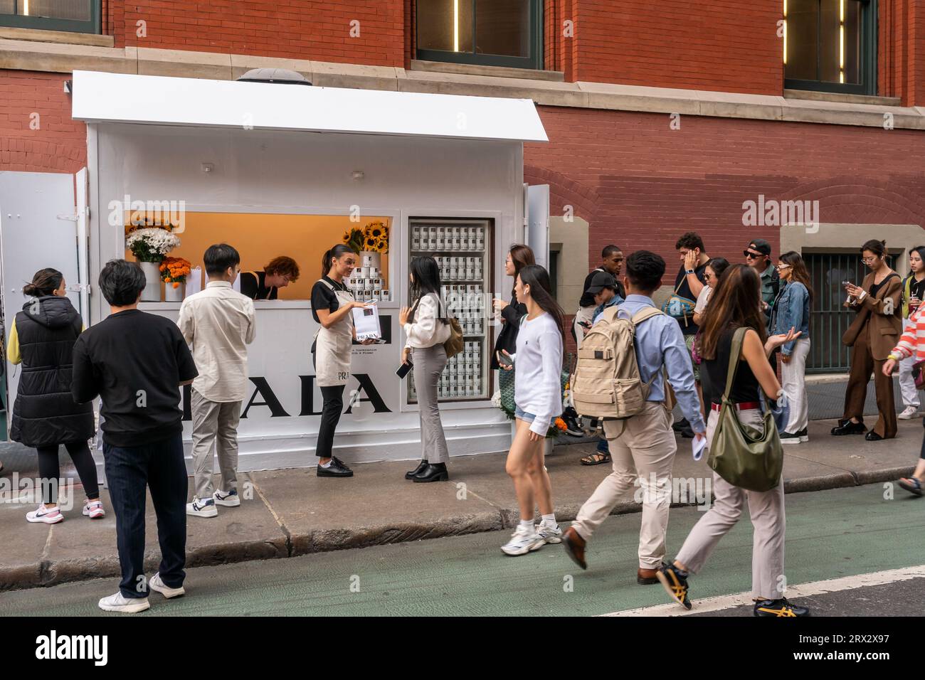 Crowds of shoppers line up for a Prada brand activation in the Soho ...