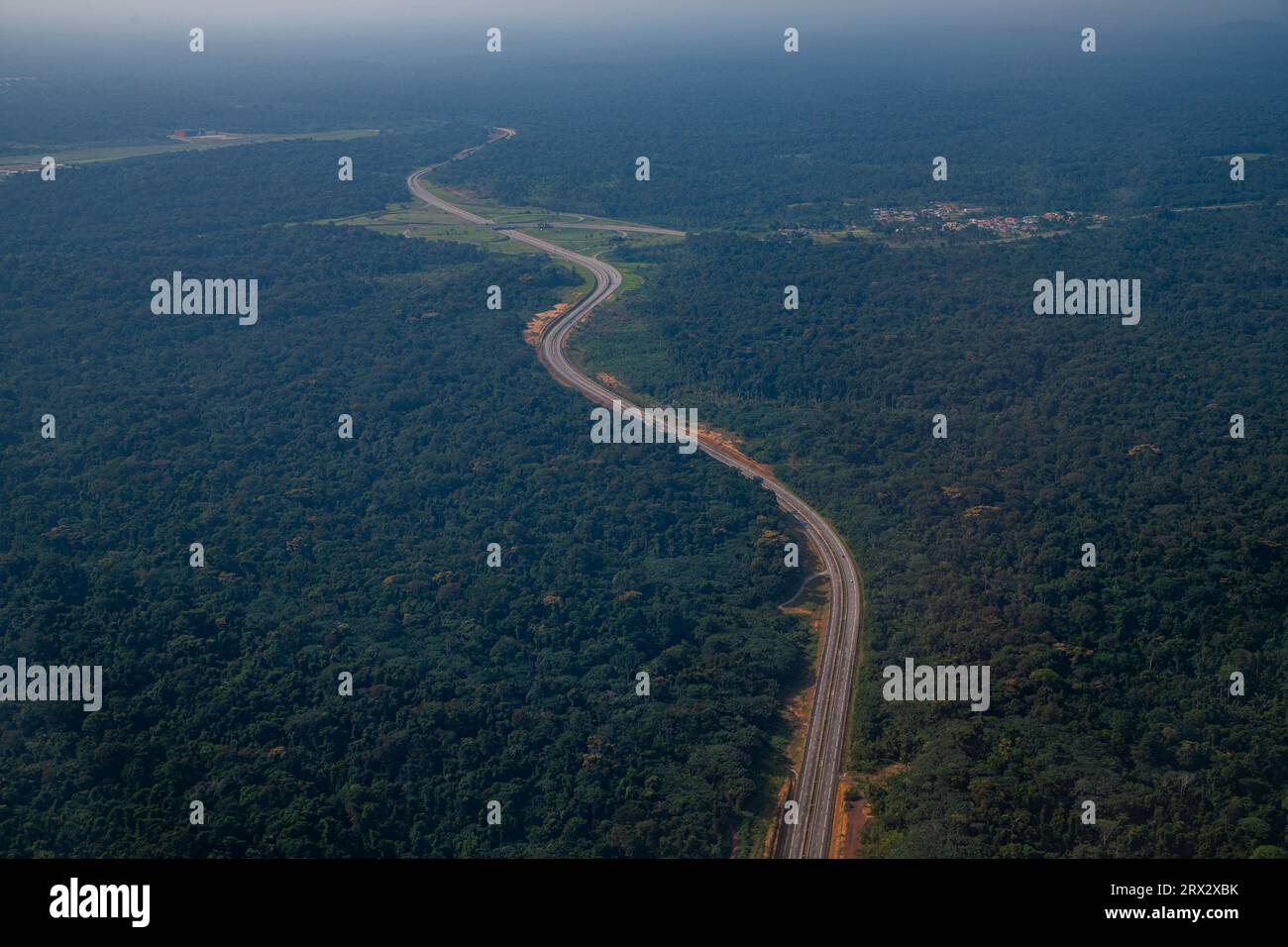 Empty highway in the jungle, future capital Ciudad de la Paz, Rio Muni ...