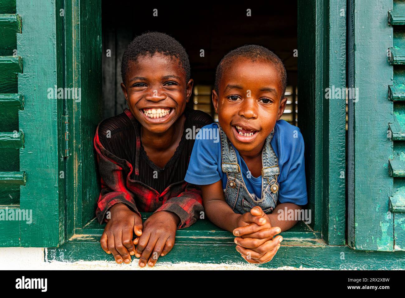 Young school kids looking out from a window, Ciudad de la Paz, Rio Muni, Equatorial Guinea ...