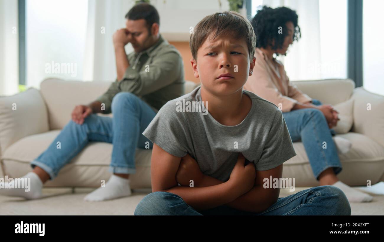 Sad offended little boy Caucasian child kid teenager son on home floor ...