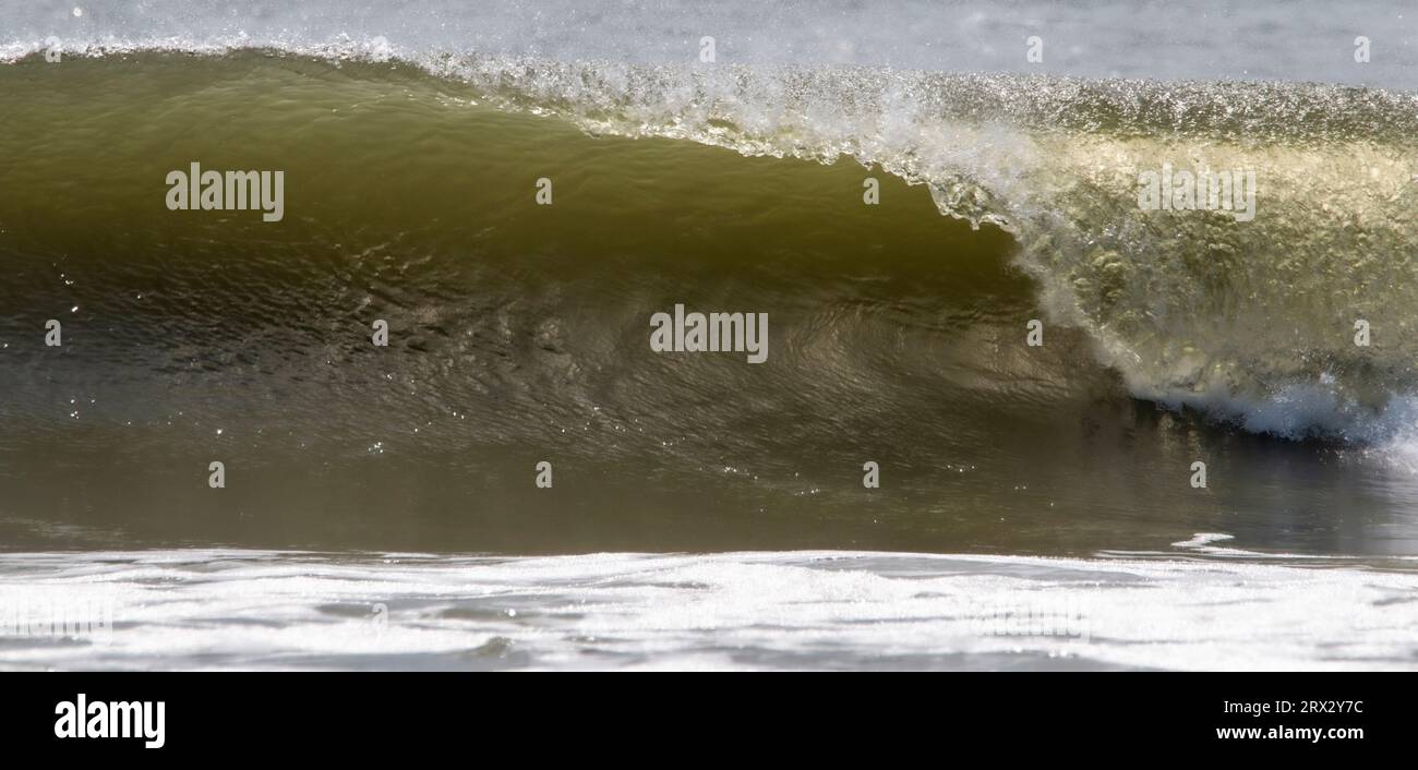 Horizontal view of a very large wave forming a curl close up at Gilgo ...