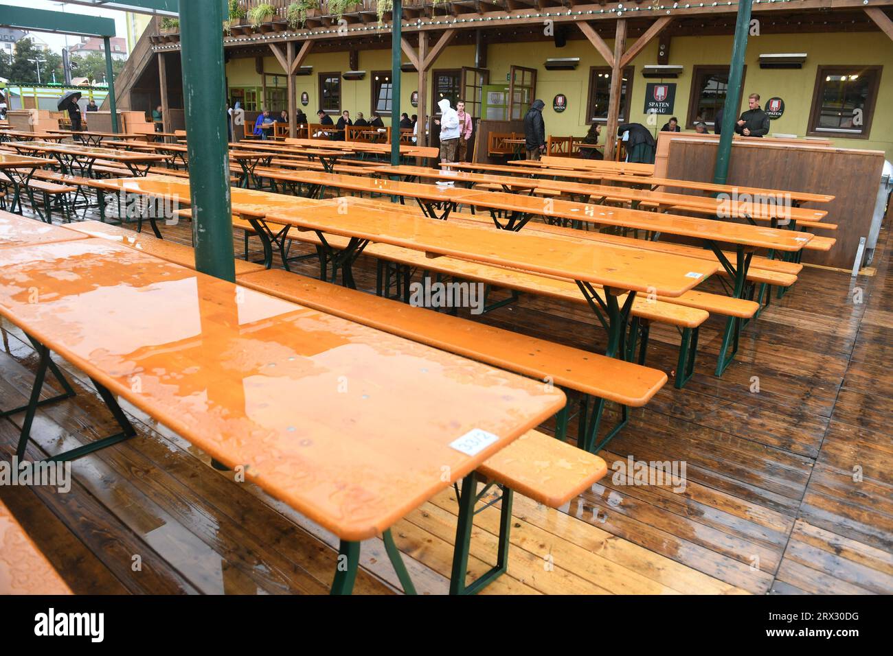 Munich, Germany. 22nd Sep, 2023. Empty beer tables stand in rainy ...