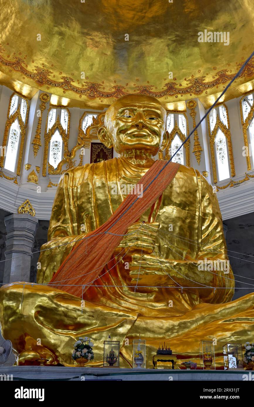 Famous monk statue cover by gold and have a name "Somdet Phra ...
