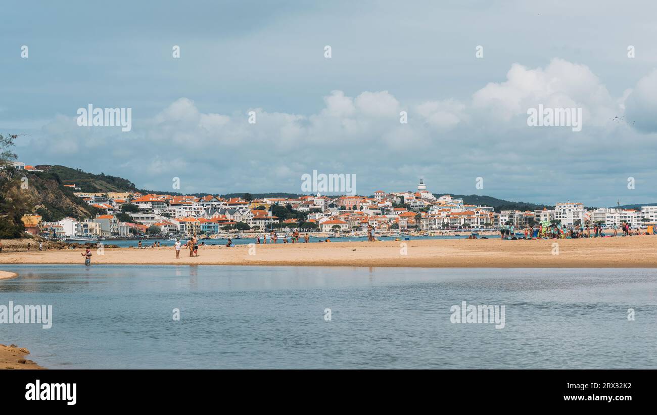 View of Sao Martinho do Porto beach, a wide white-sand beach, backed by ...