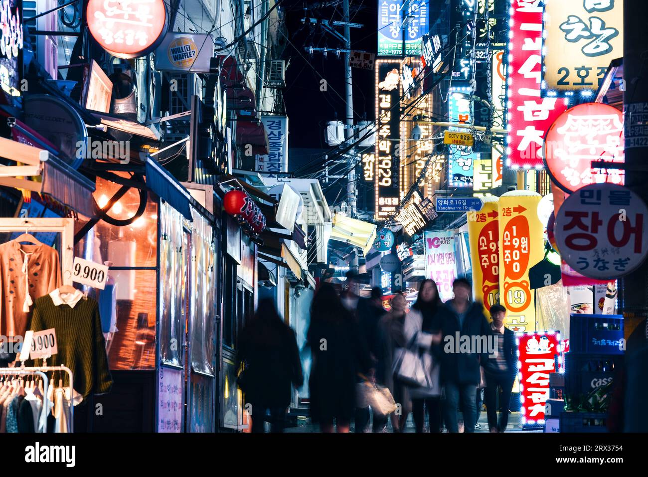 A bustling street scene at night in in Seoul's student district, Seoul ...