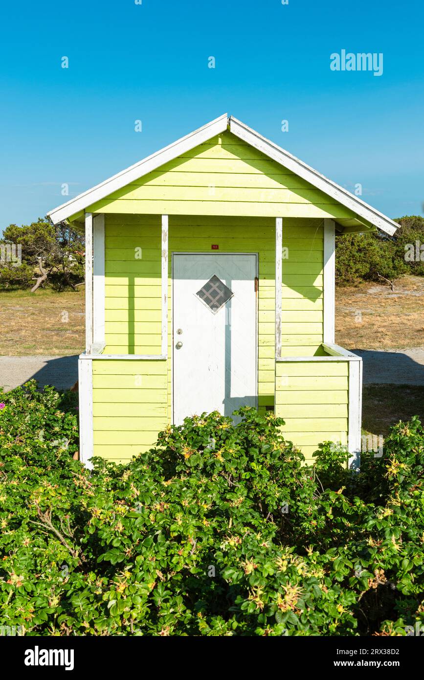 Frontal view of the wooden front of a green bathing hut on the beach of ...