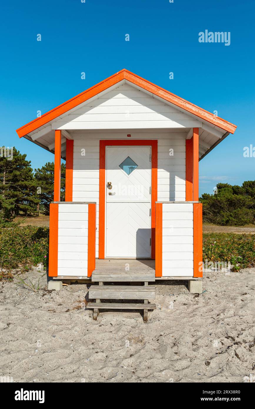 Frontal view of the wooden front of a orange white bathing hut on the ...