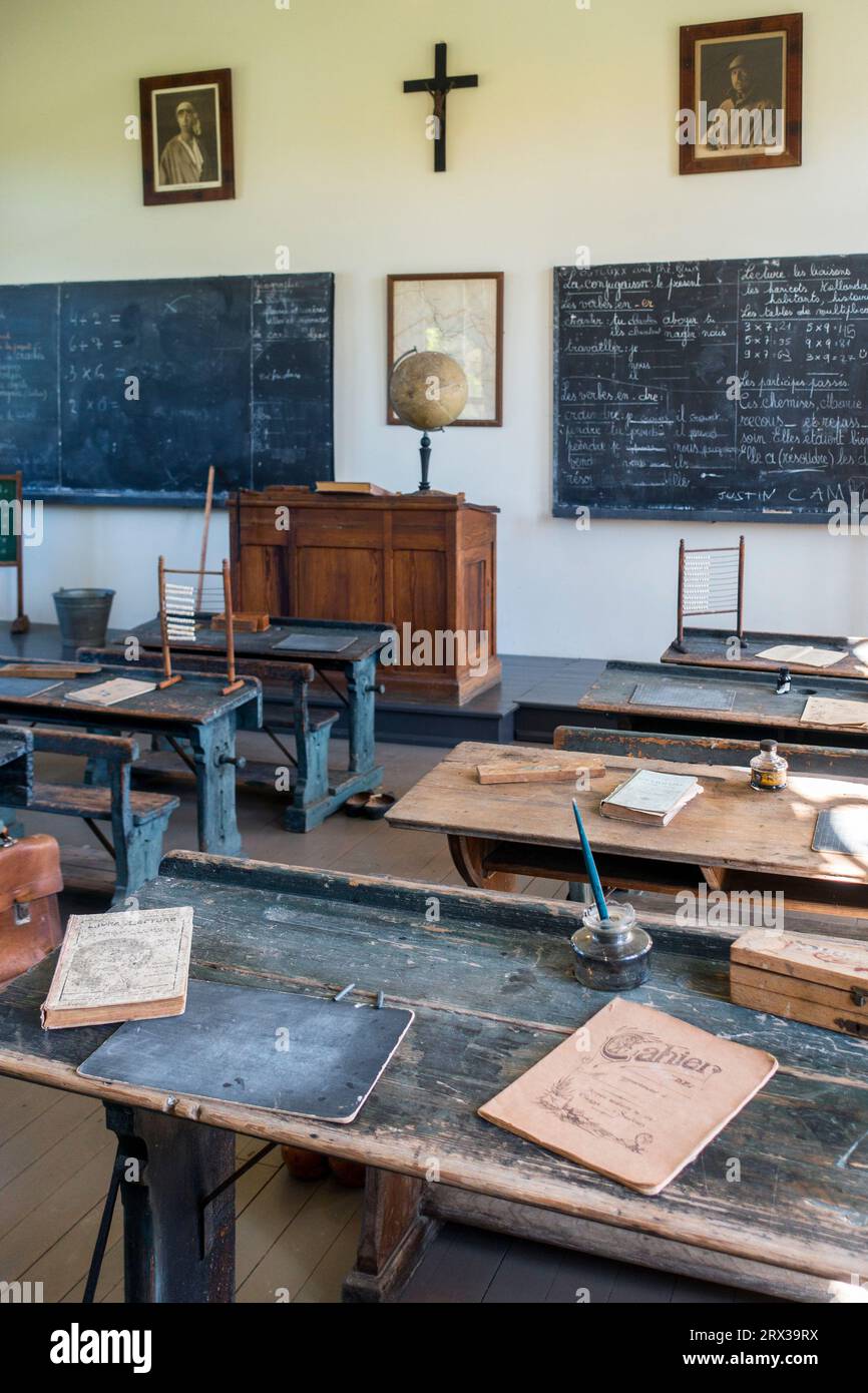 19th century classroom of country school showing desk with slate, inkpot and notebook at museum ...