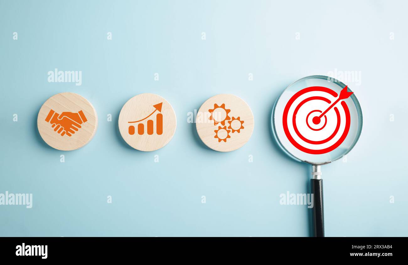 Target icon under magnifying glass Stock Photo - Alamy