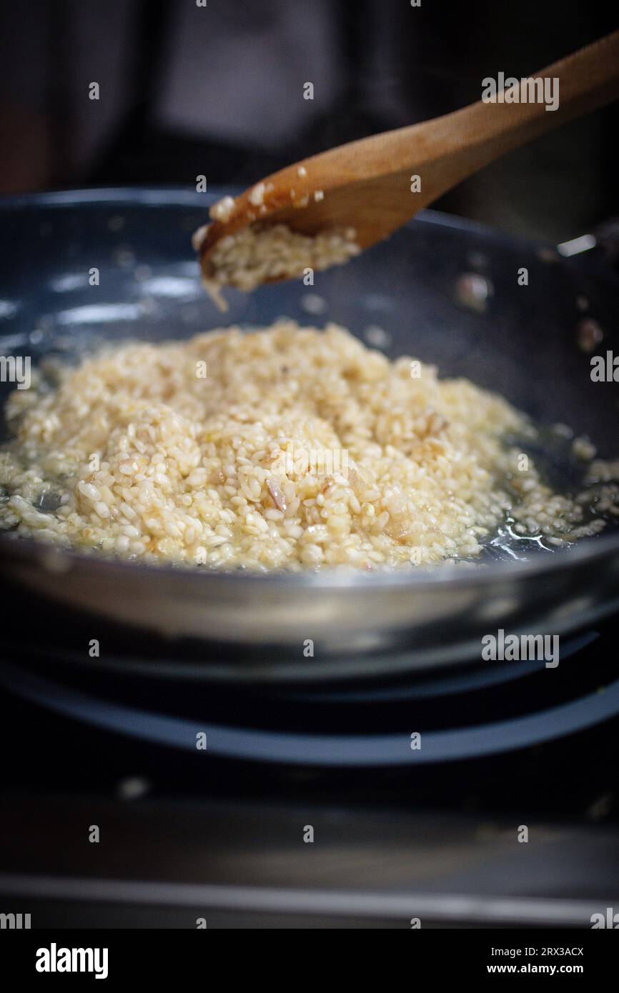 Cooking Risotto on a portable induction cooker portable Stock Photo - Alamy