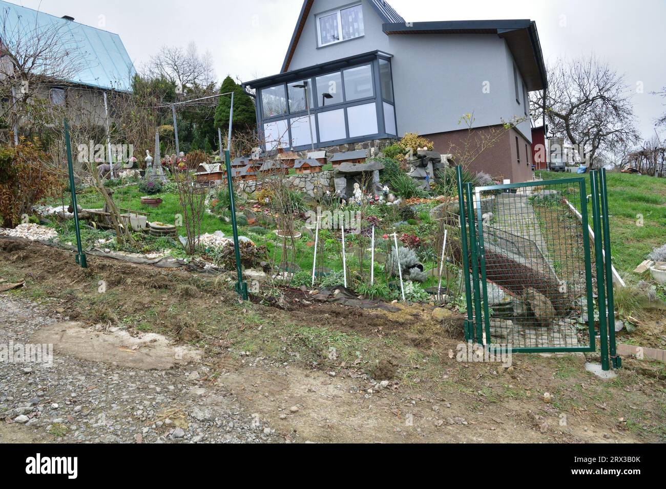 Green metal pillars in the ground ready for the fence, a traditional ...