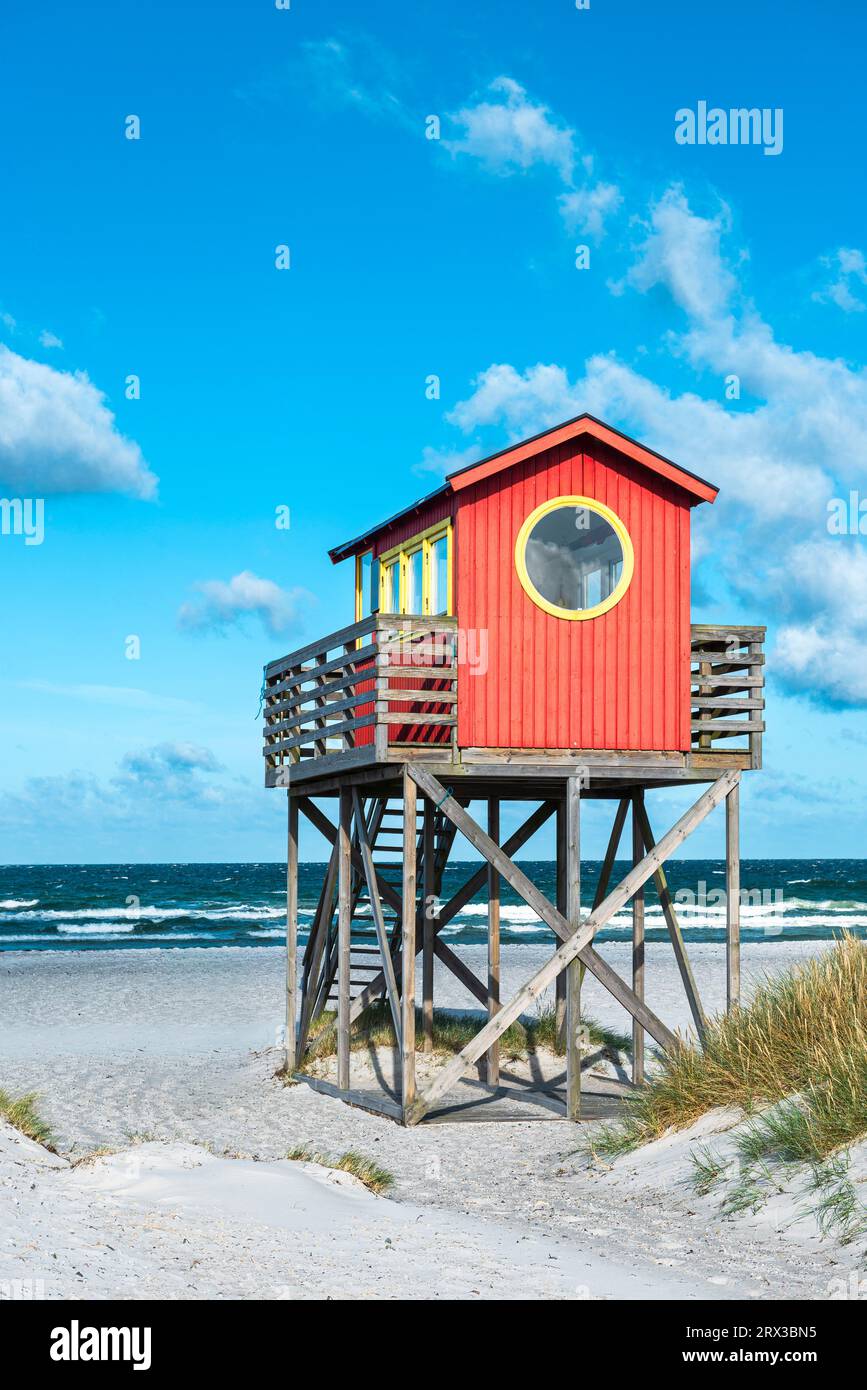 Red wooden lifeguard observation tower on stilts at the beach bar in ...