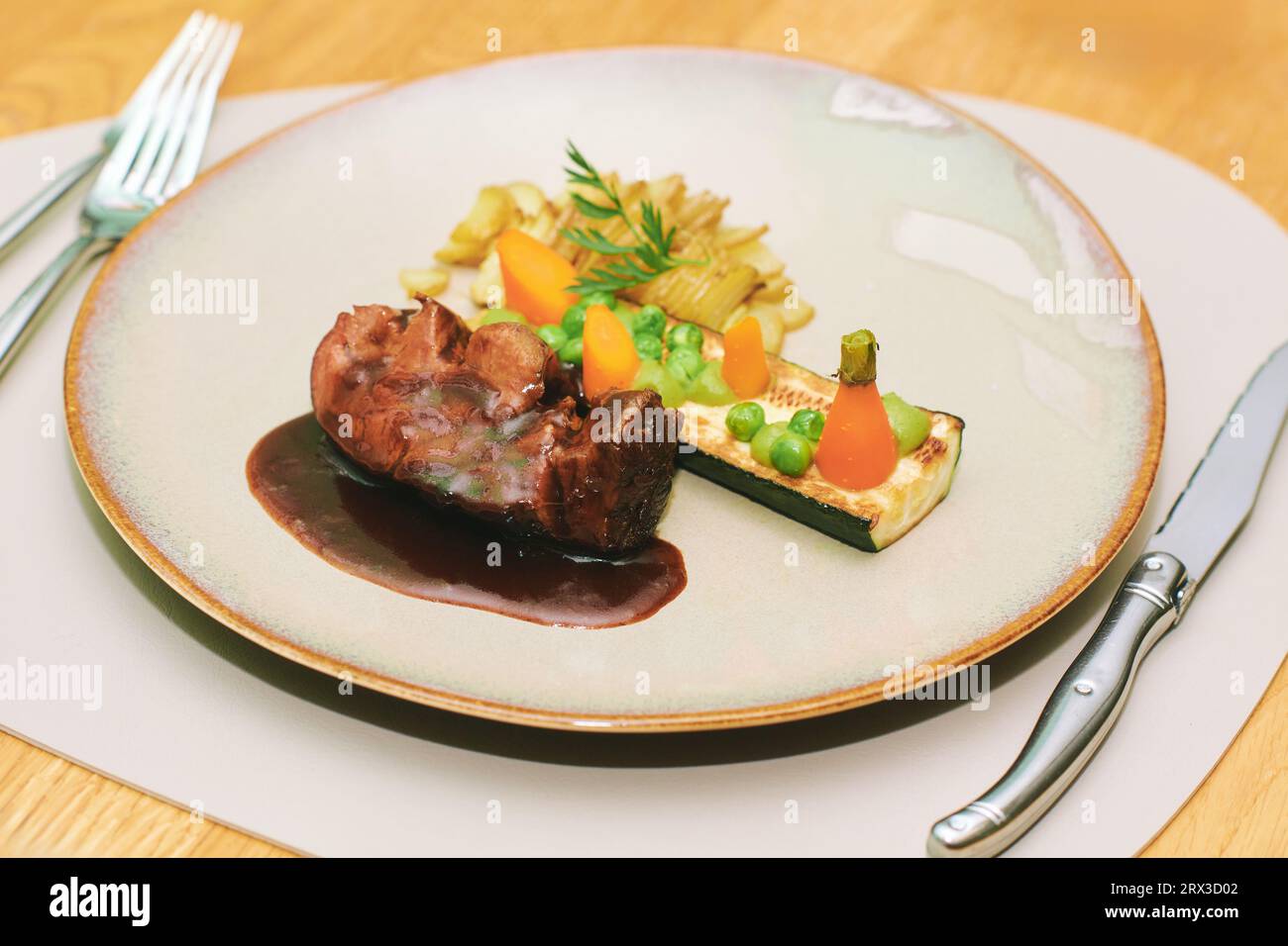 Sautéed beef tenderloin with red wine sauce served with seasonal ...