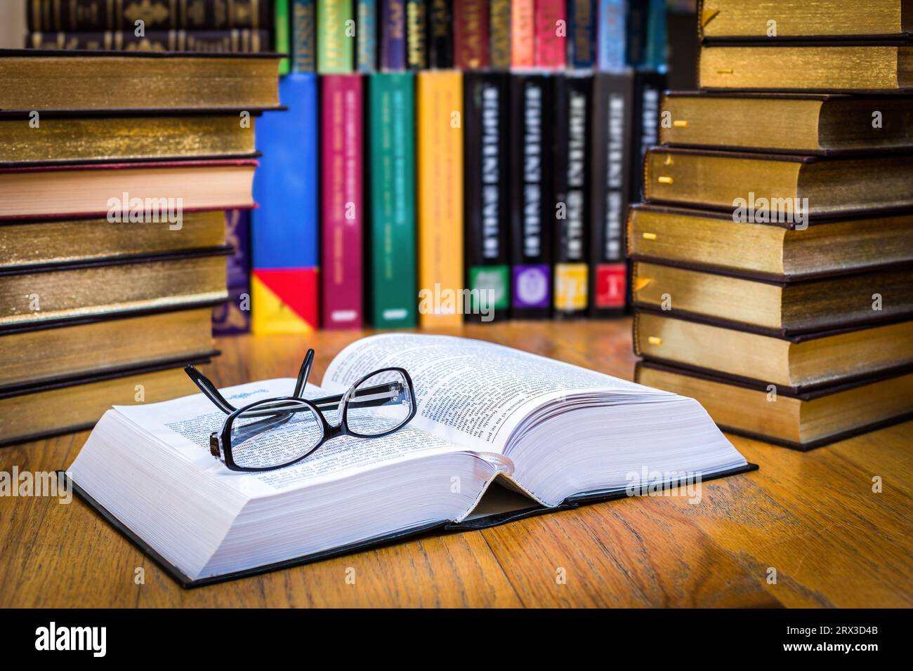 Open book with reading eyeglasses Stock Photo - Alamy