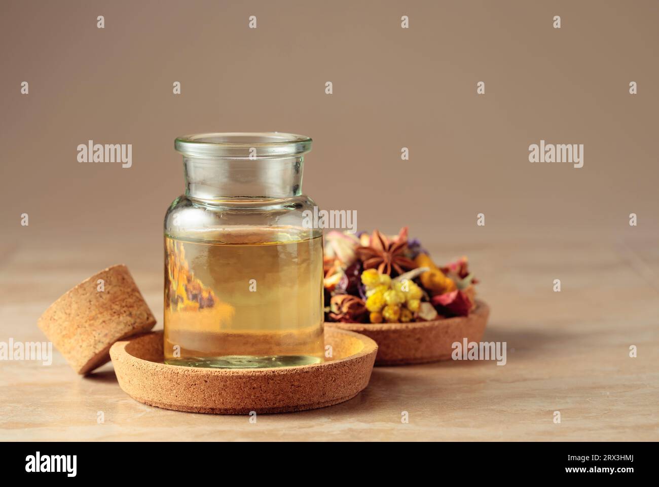 Essential oil or herbal tincture in a small glass bottle. Mix of dried ...