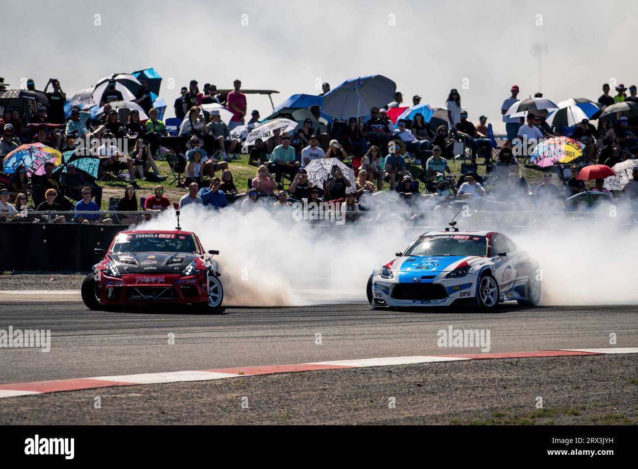 Jeff Jones (left) and Jhonnattan Castro (right) slide their drift cars ...