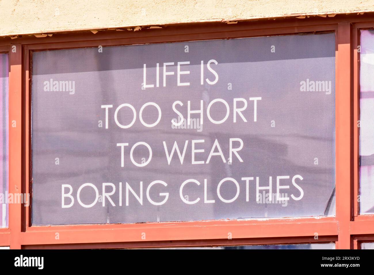 Witty sign in the front window of a clothing store Stock Photo - Alamy