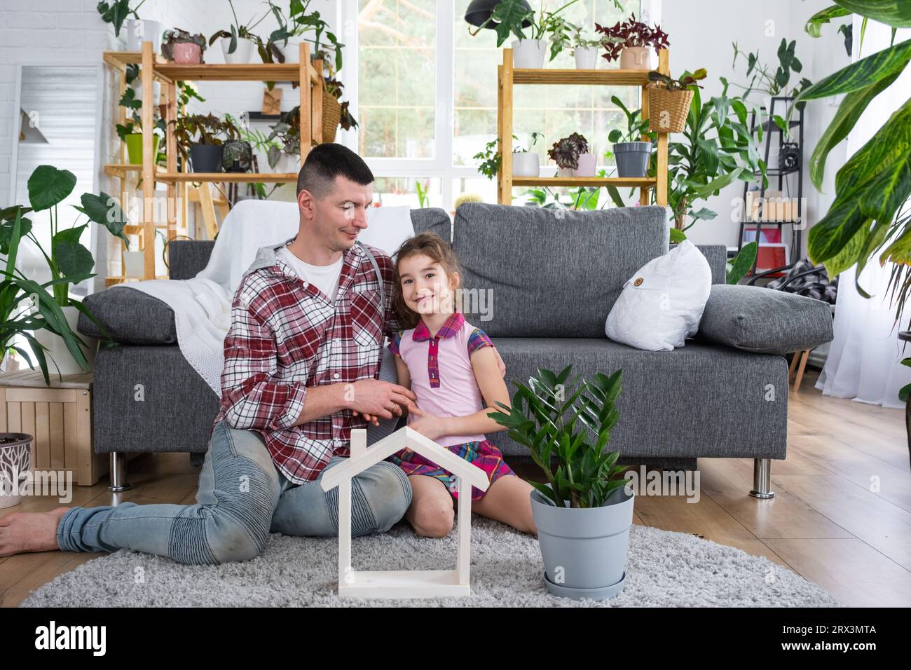 Incomplete family dad and daughter are enjoying new home, sitting on ...
