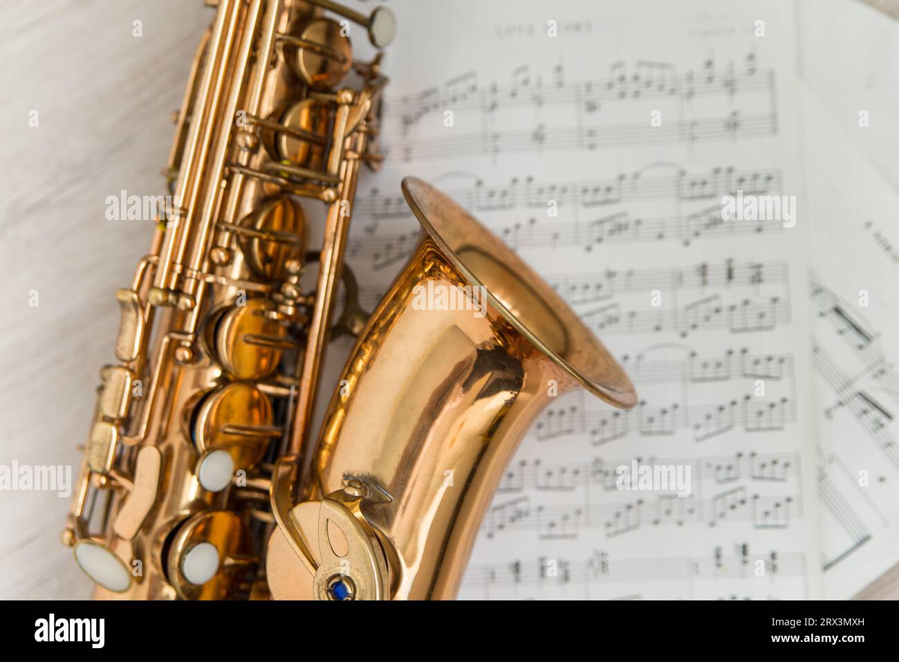 Flatlay picture of the saxophone laying on the note sheets Stock Photo ...