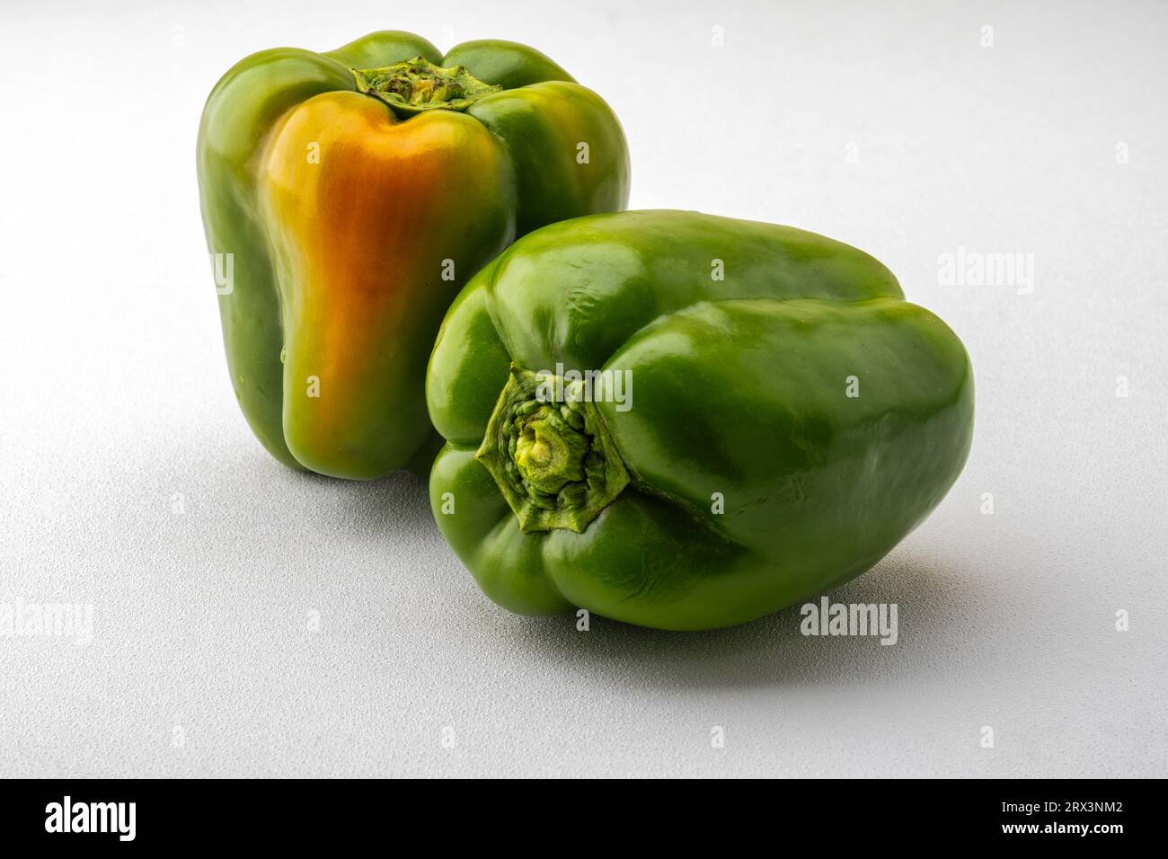 Fresh green bell peppers, or capsicum, beautifully arranged on a clean ...