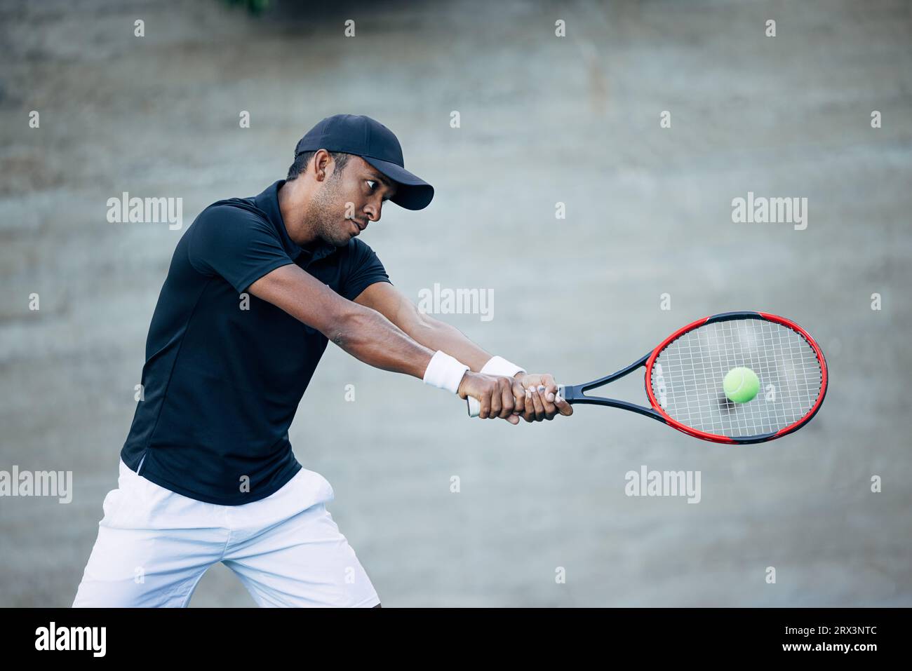 Professional tennis player hitting ball with racket while playing ...