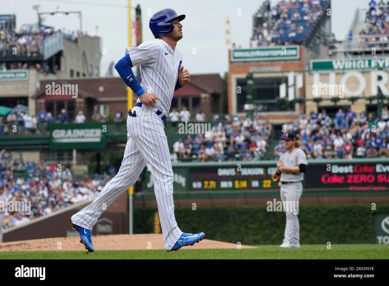 Chicago Cubs' Cody Bellinger walks to first base after being hit by a ...