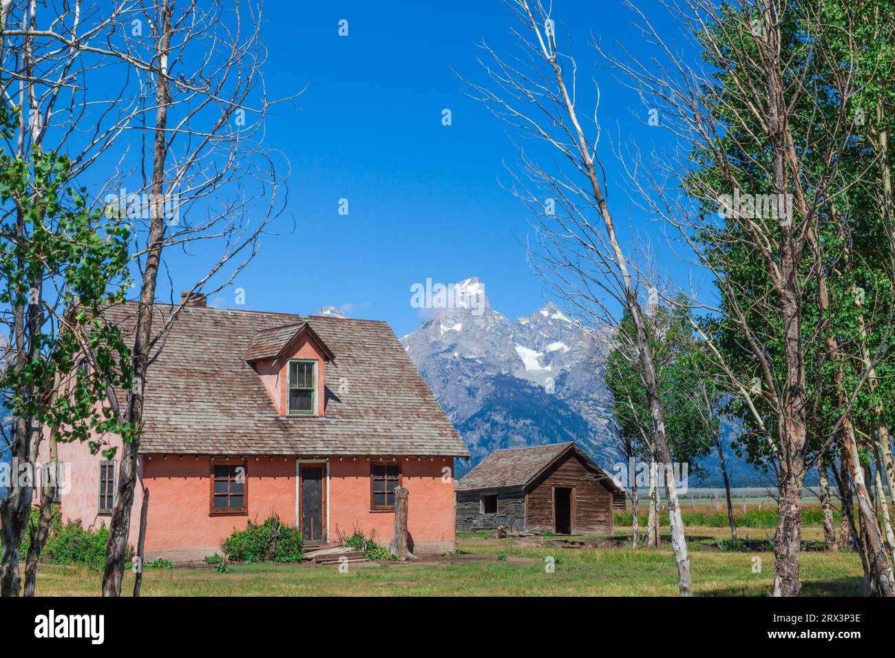 Abandoned farm building on "Mormon Row" wtih the Grand Tetons Mountain ...