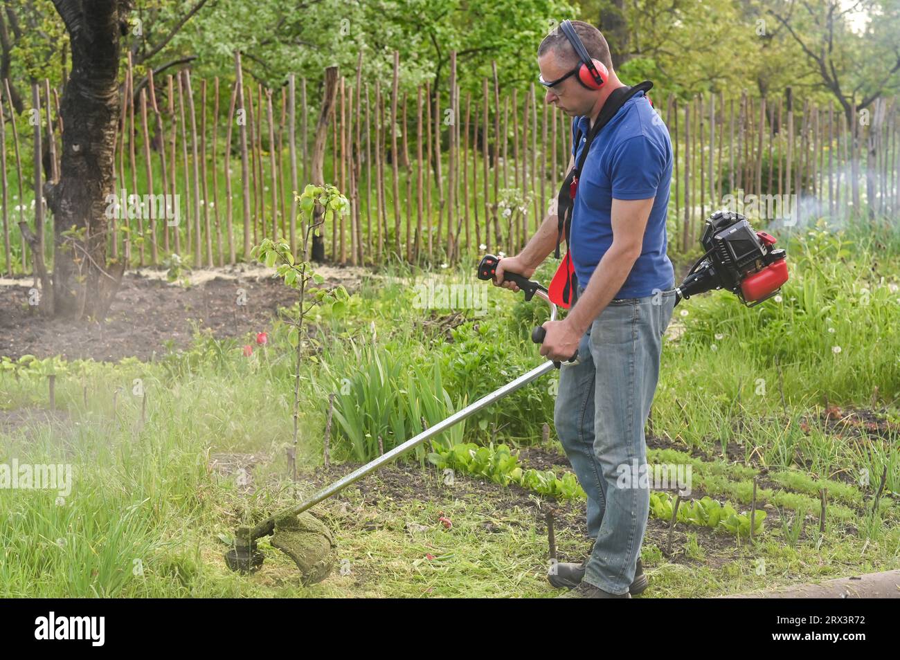 Worker mowing tall grass electric hi-res stock photography and images ...