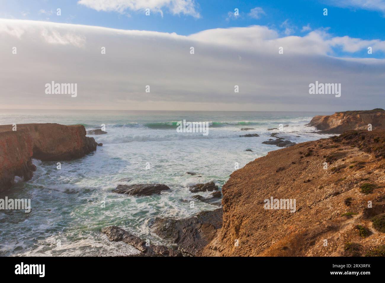 White-capped crashing waves and high surf, with storm coming in, at ...