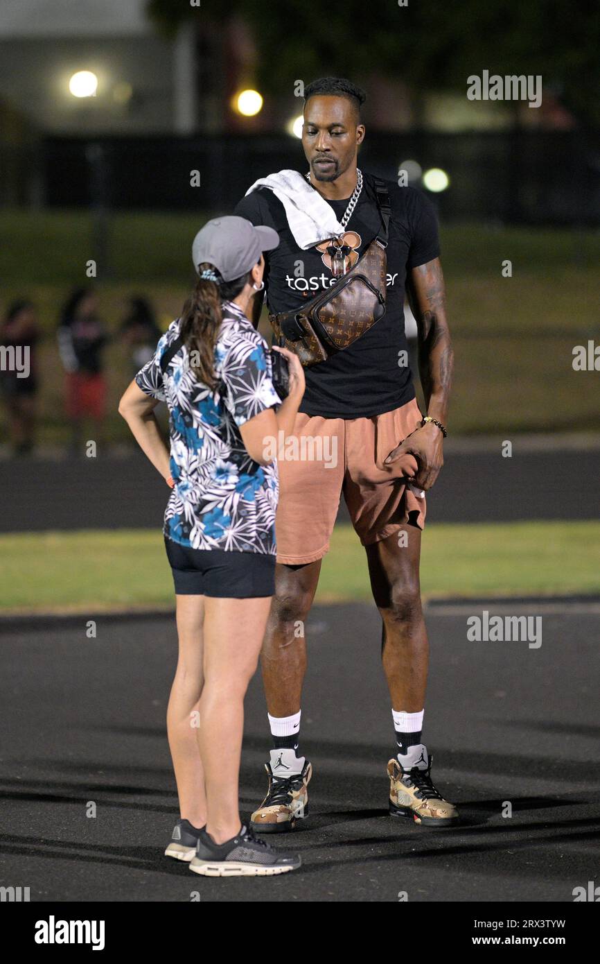 NBA basketball player Dwight Howard talks with school principal Christy ...