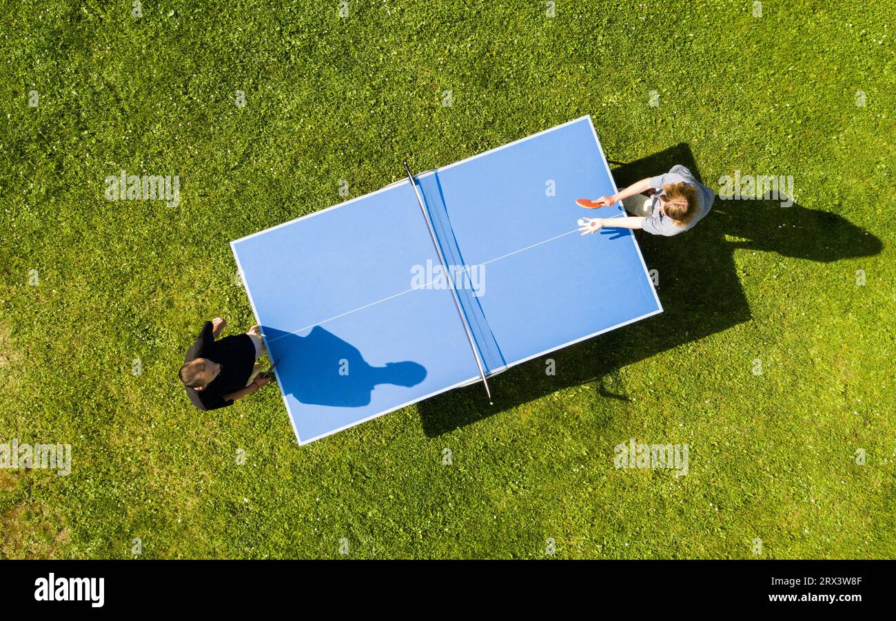 Aerial view people playing ping pong match outdoor. Top view two boys ...