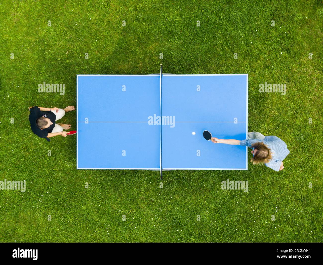 Aerial view people playing ping pong match outdoor. Top view two boys ...