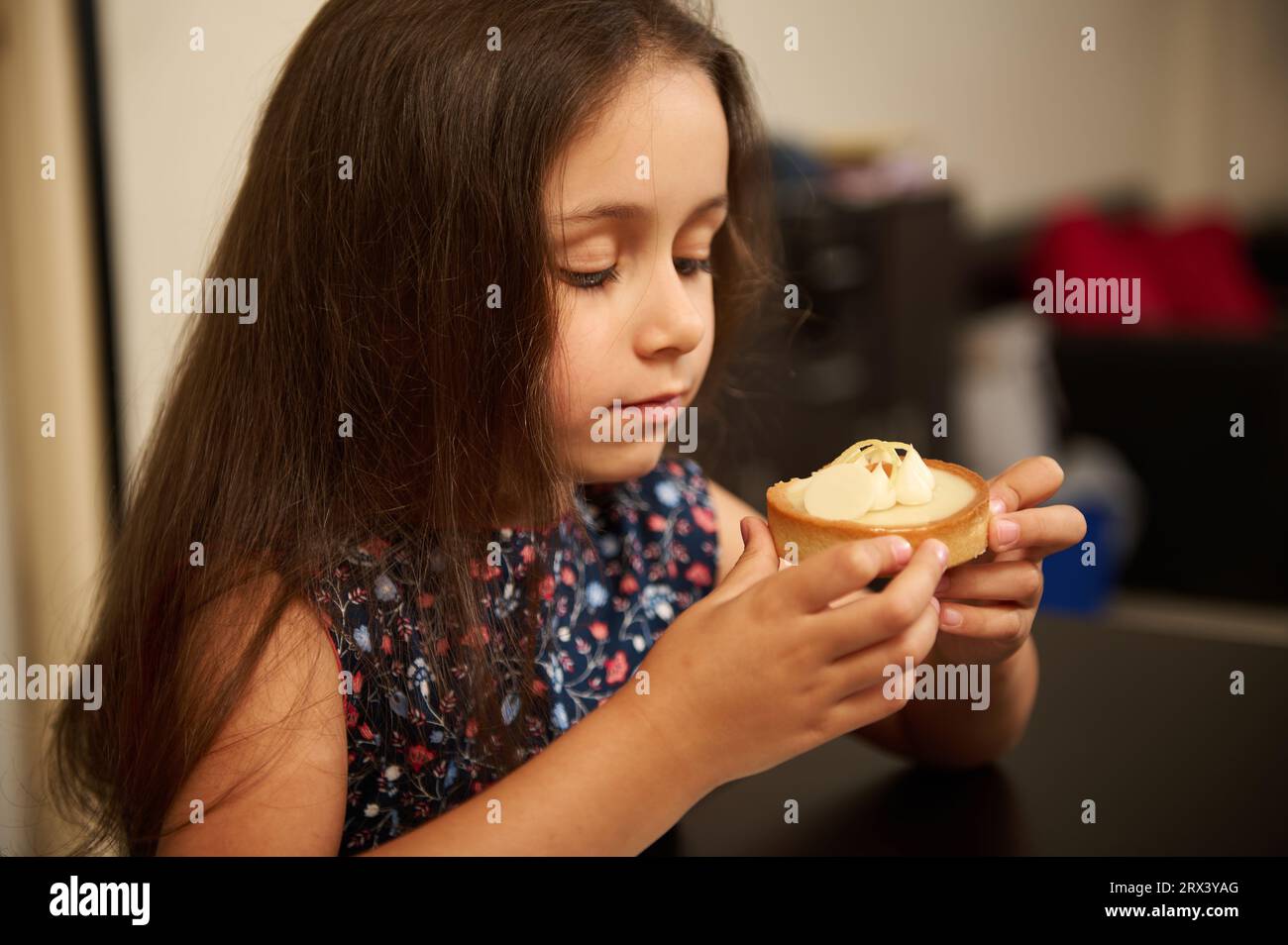 Closeup portrait of a Caucasian adorable little kid girl snacking with ...