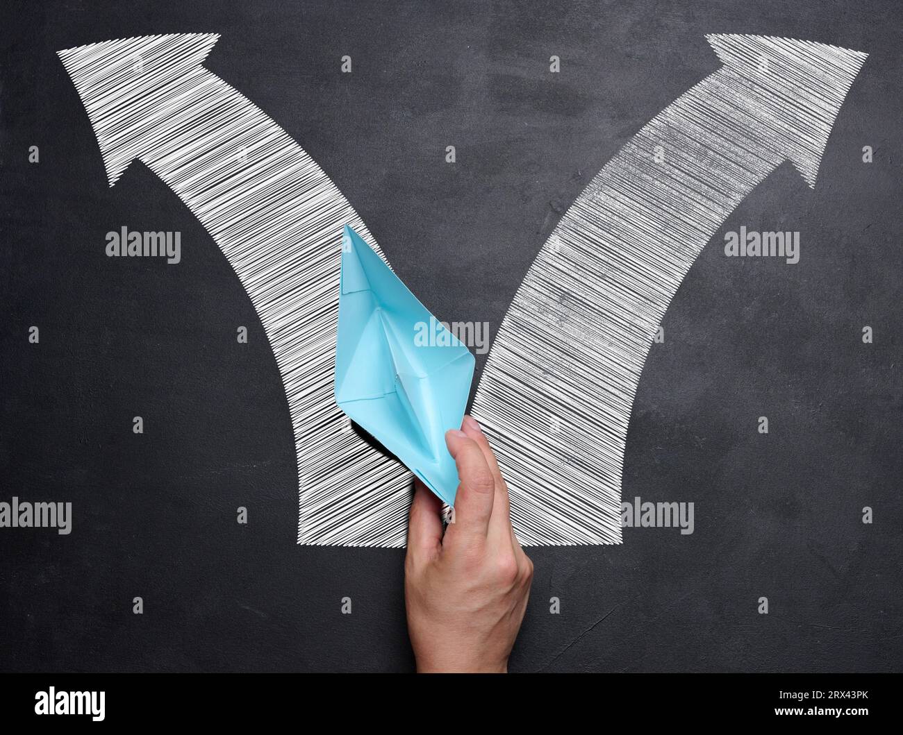 Hand holding a blue paper boat, concept of finding solutions, choosing ...